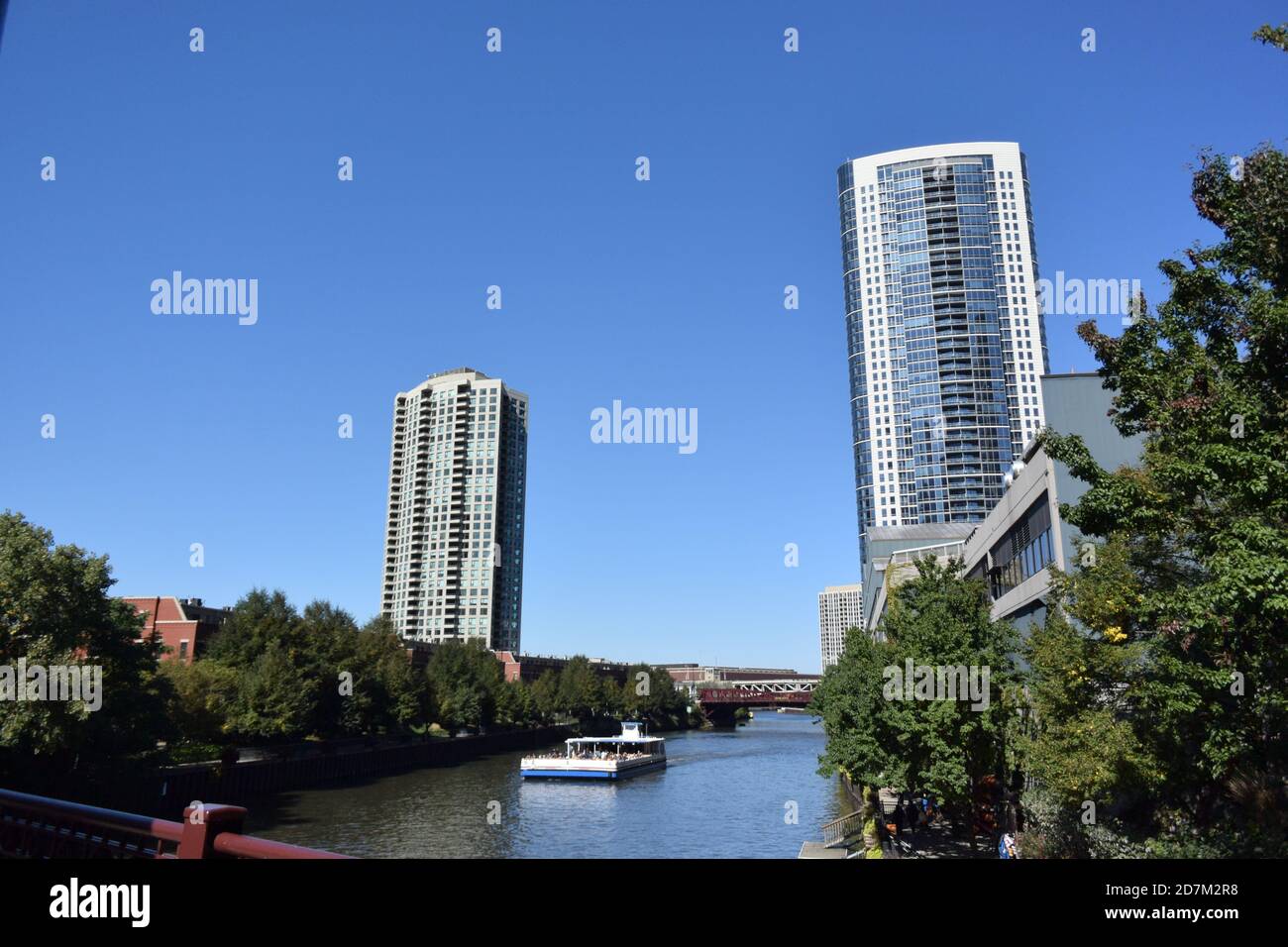 Urban river scene with high-rise apartments low rise buildings tourist ...
