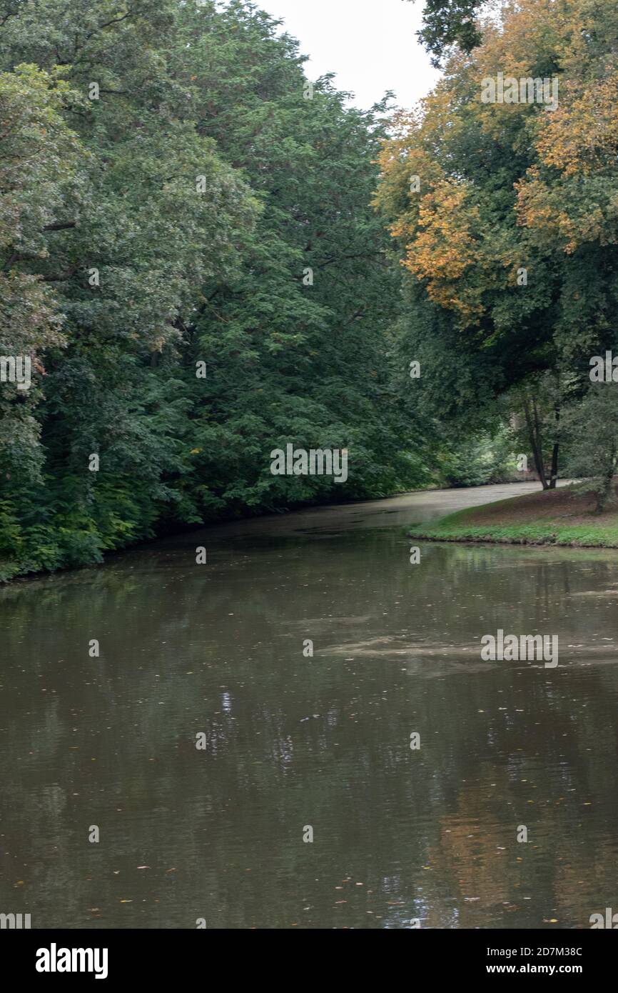 Vertical shot of a lake surrounded by greenery in a Bremen park ...