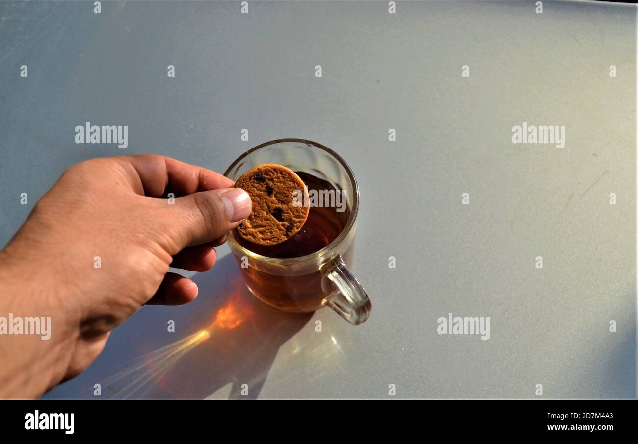 Biscuit and turkish tea with colorful shadow. Dipping biscuits into ...