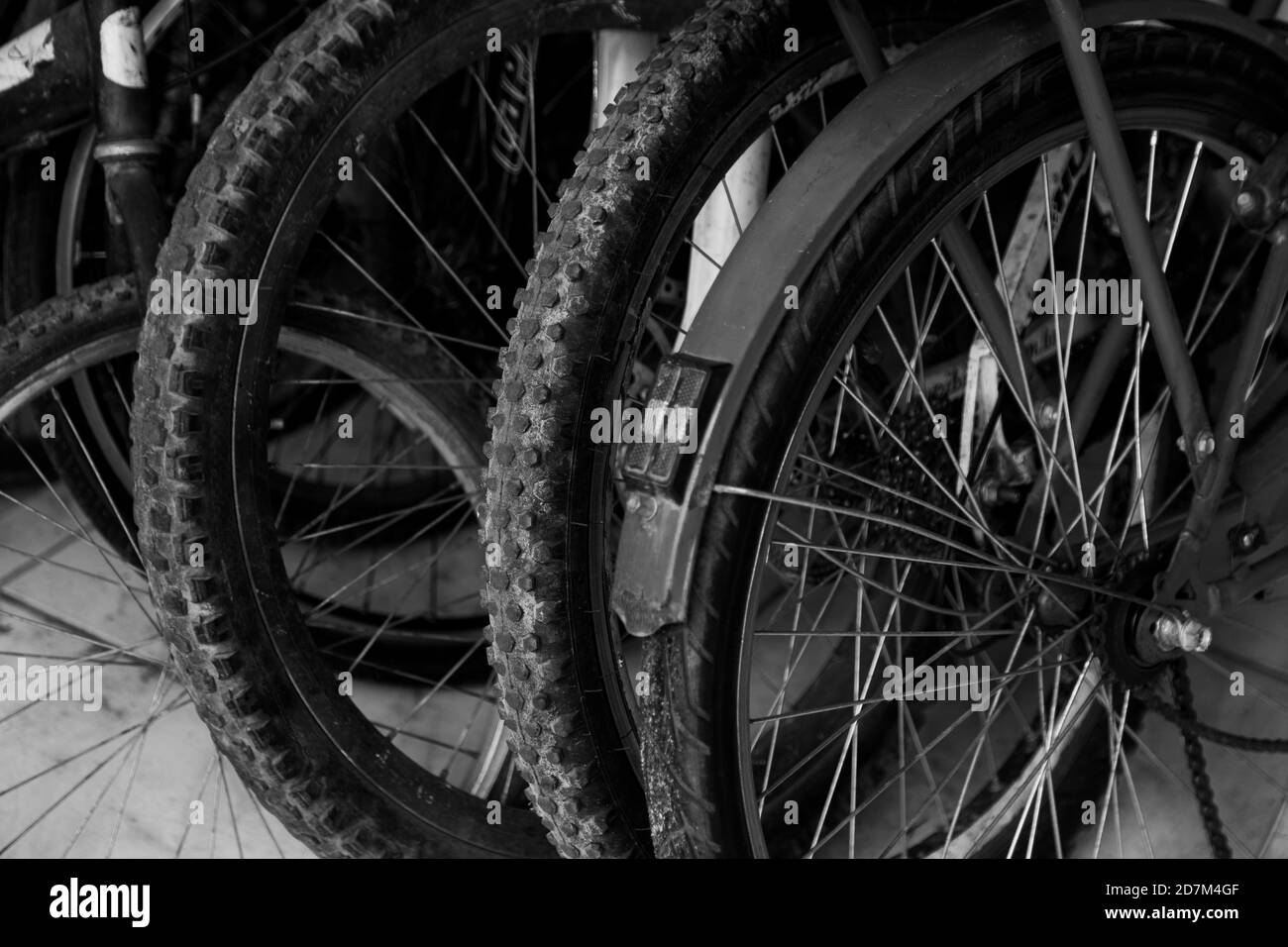 Grayscale shot of tires of bicycles in the garage Stock Photo - Alamy