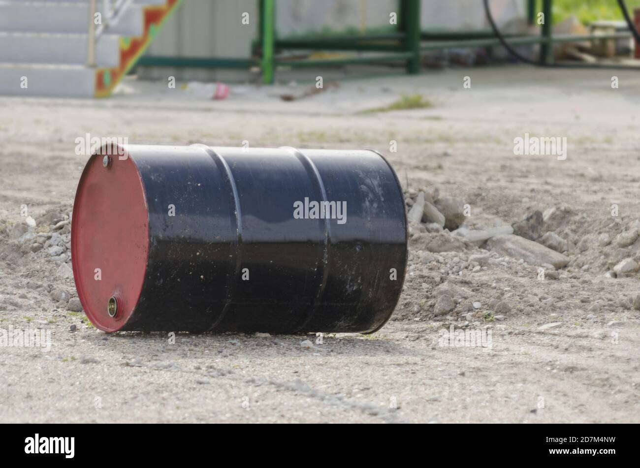 Closeup of a black overturned barrel on the ground Stock Photo - Alamy