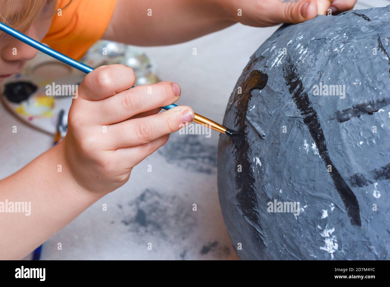 Child doing art and craft the boy is painting his project at home Stock ...