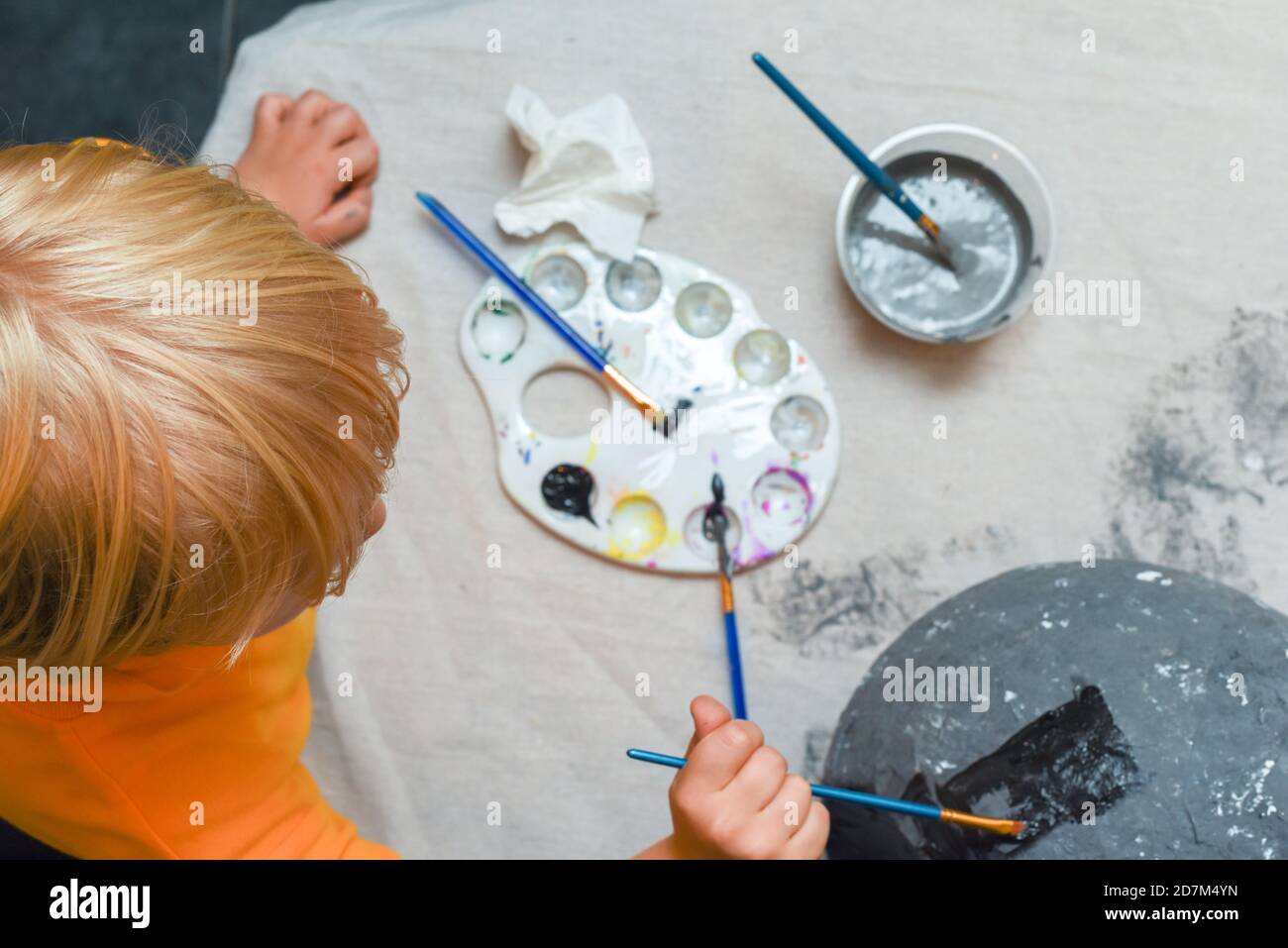 Child doing art and craft the boy is painting his project at home Stock ...