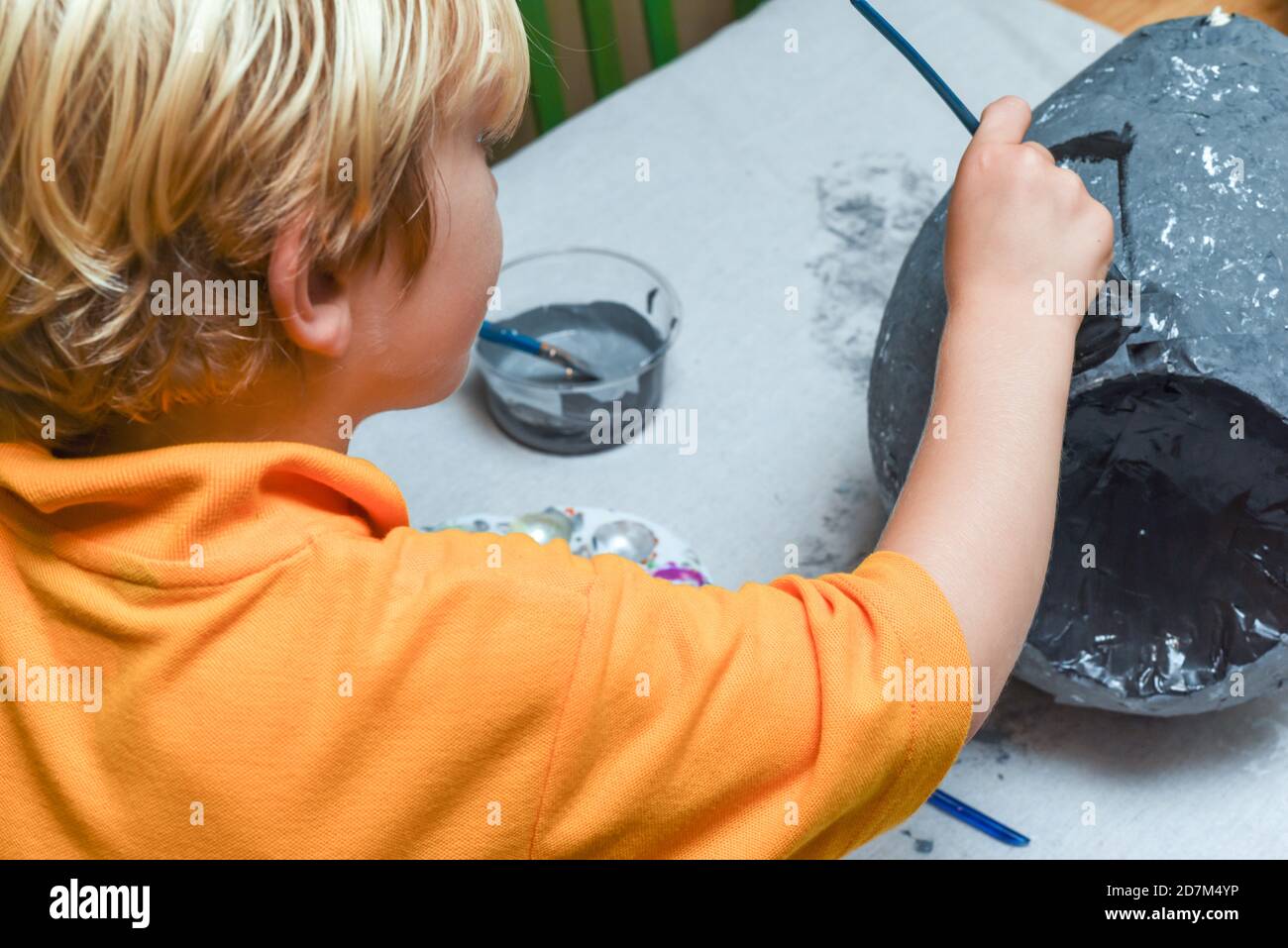 Child doing art and craft the boy is painting his project at home Stock ...