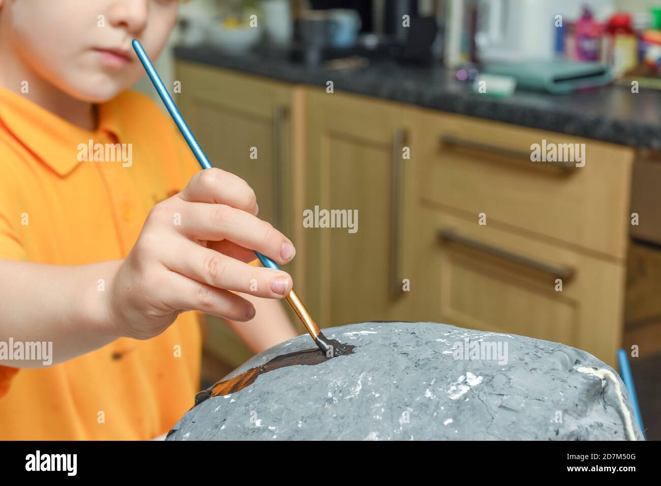 Child doing art and craft the boy is painting his project at home Stock ...