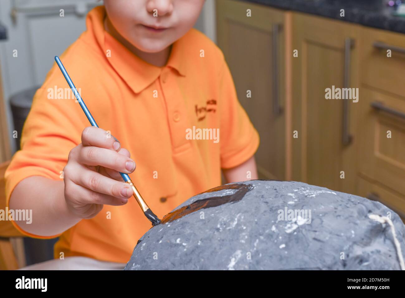Child doing art and craft the boy is painting his project at home Stock ...