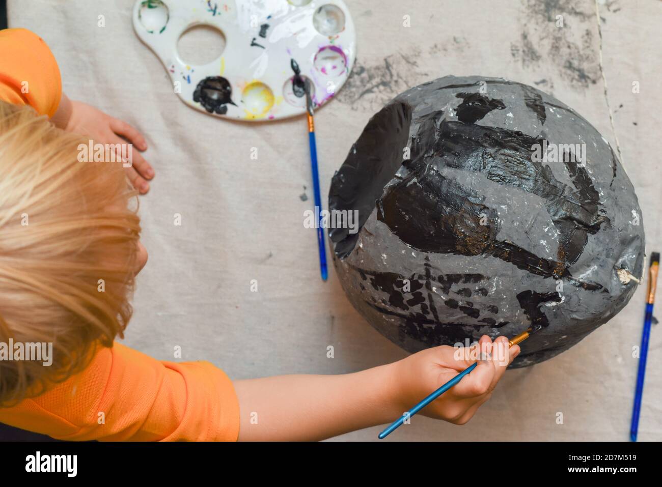 Child doing art and craft the boy is painting his project at home Stock ...