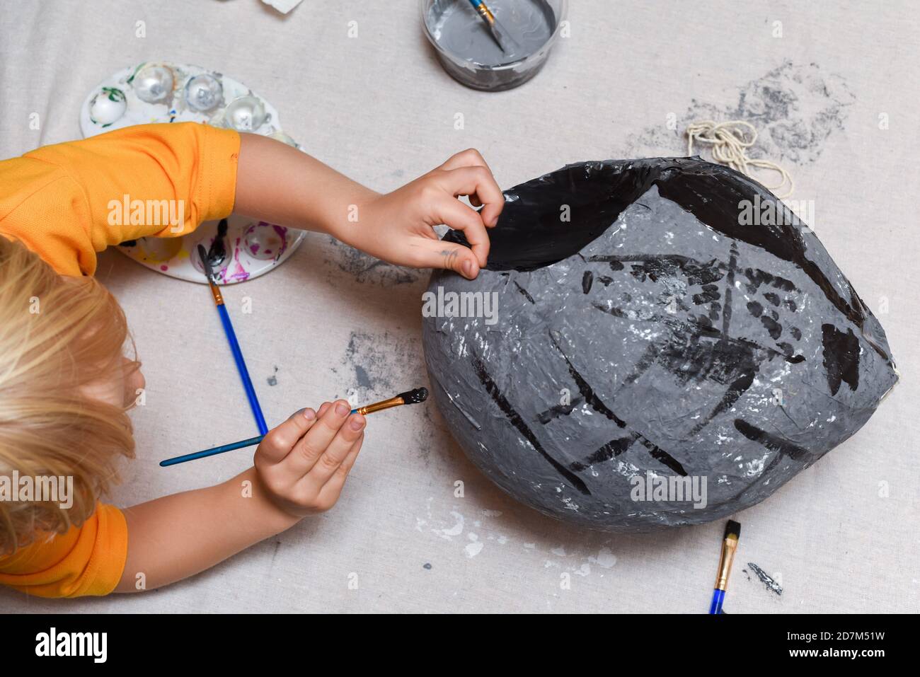 Child doing art and craft the boy is painting his project at home Stock ...