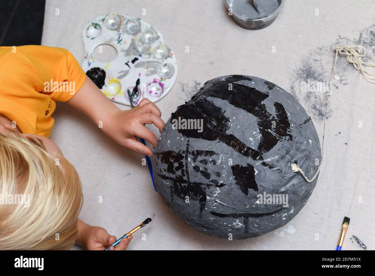 Child doing art and craft the boy is painting his project at home Stock ...