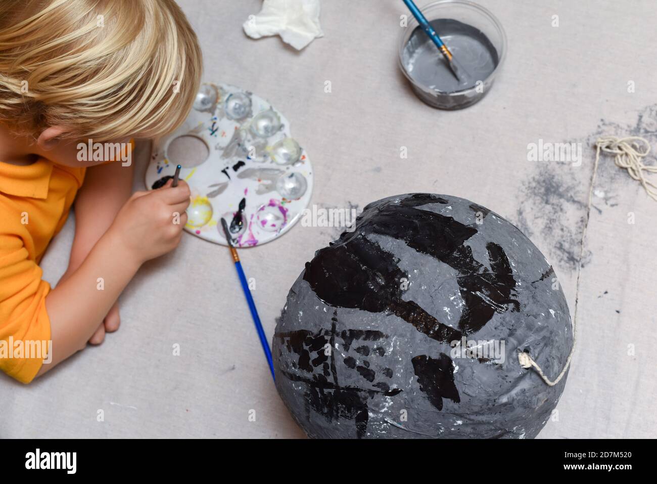 Child doing art and craft the boy is painting his project at home Stock ...