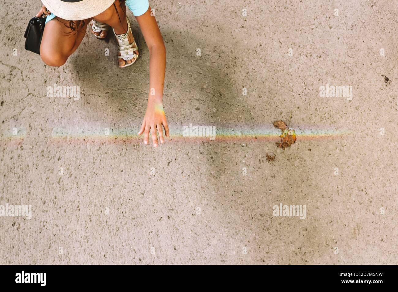 Touching rainbow. Good times are coming. A girl holding her hand under ...