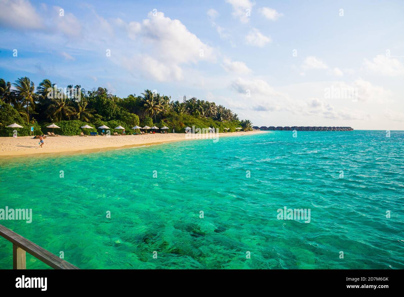 Beautiful wavy ocean hitting the sandy beach in the Maldives Island ...