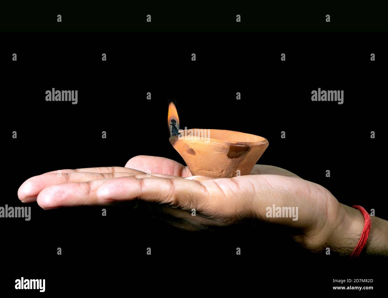 Hand holding diya hi-res stock photography and images - Alamy