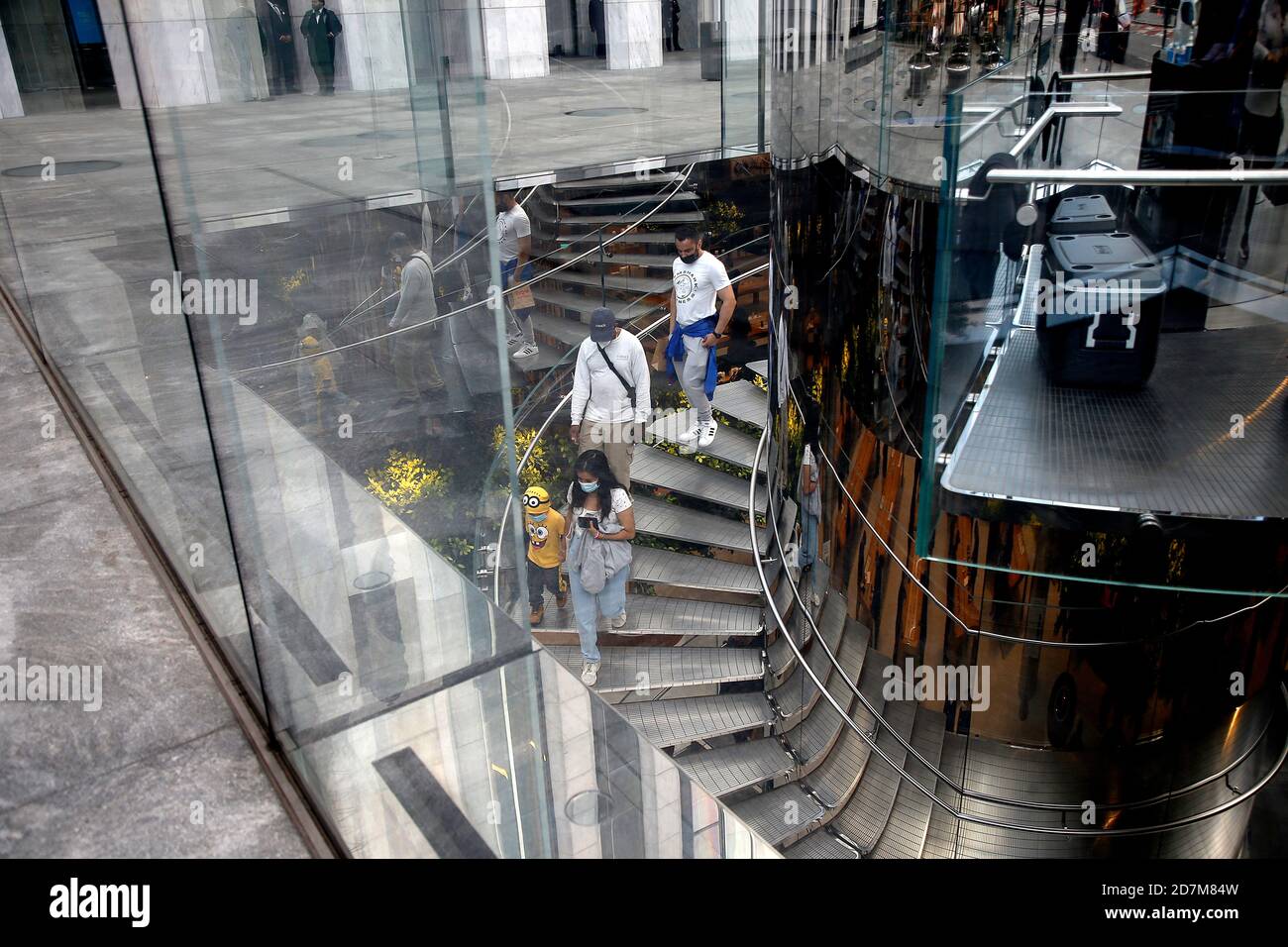 New York, United States. 23rd Oct, 2020. Customers walk down a glass ...