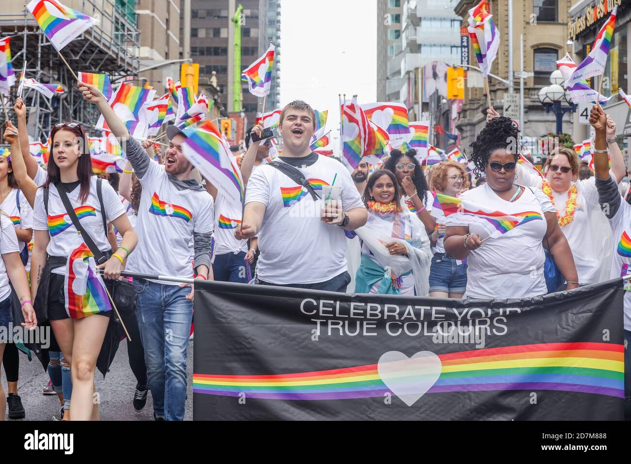 Participants marching while holding flags and banners during the ...
