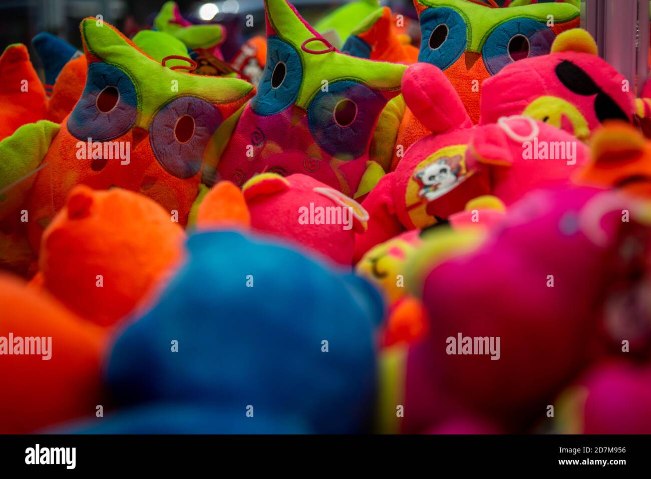 Close up of colorful soft toys of funny animals inside a spending ...