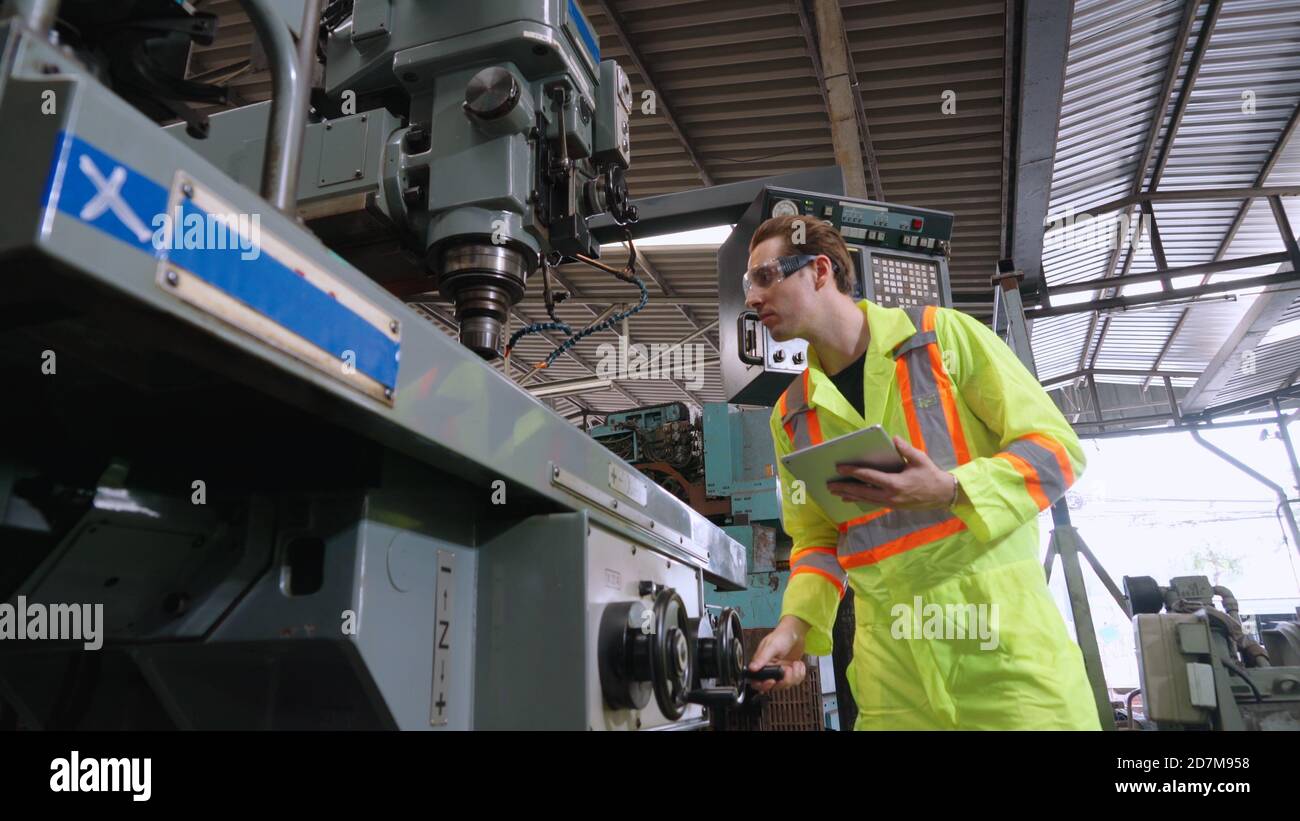 Smart factory worker using machine in factory workshop . Industry and ...