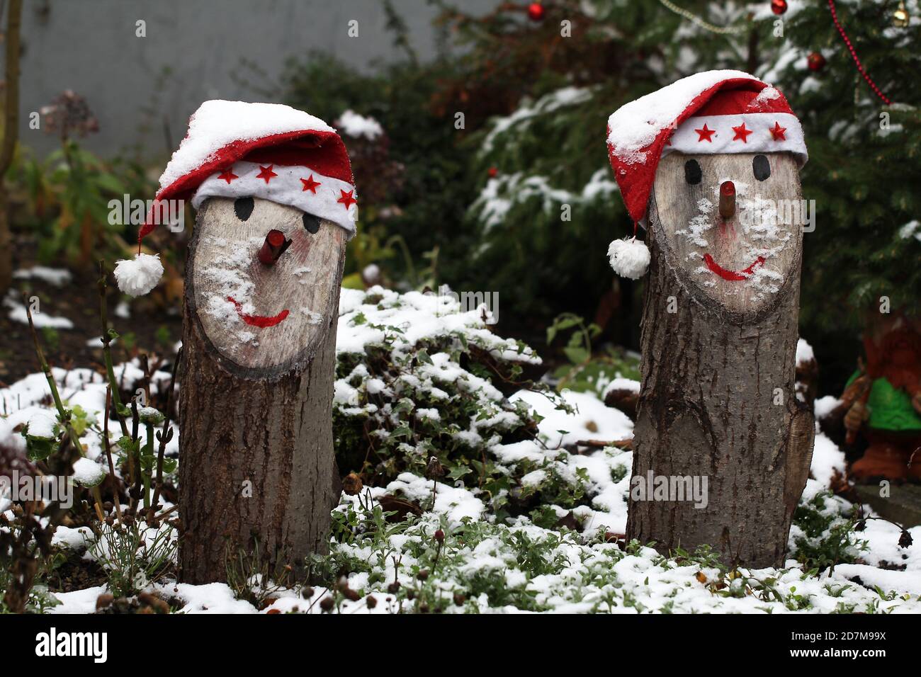 Shallow focus of cut tree trunks decorated like humans and wearing ...