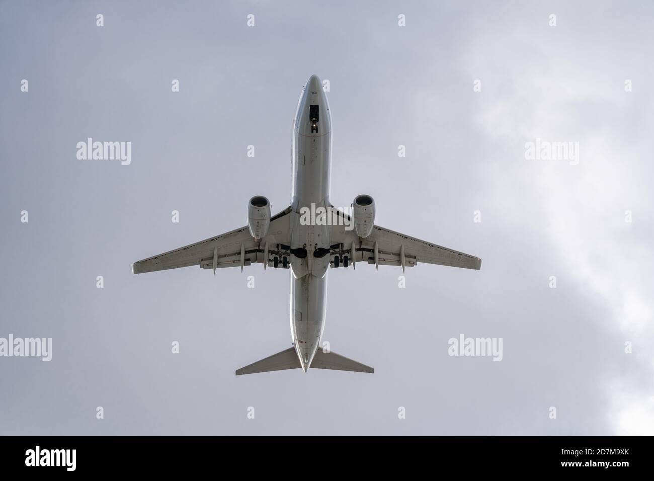 Underside of an airplane on white sky Stock Photo - Alamy