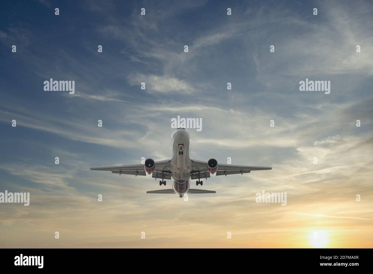 Jet airplane approaching in sunset hi-res stock photography and images ...