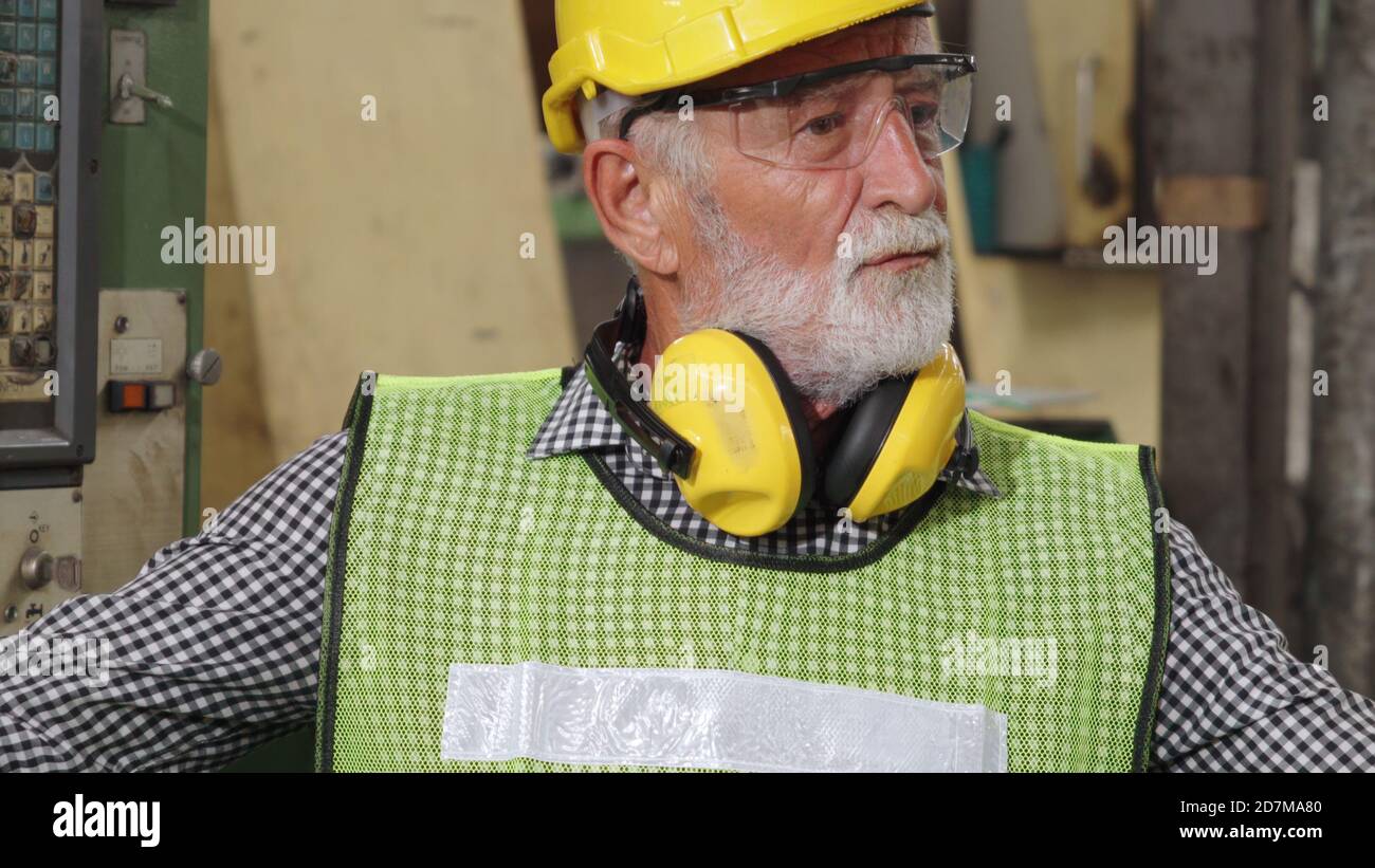 Senior factory worker or engineer close up portrait in factory ...