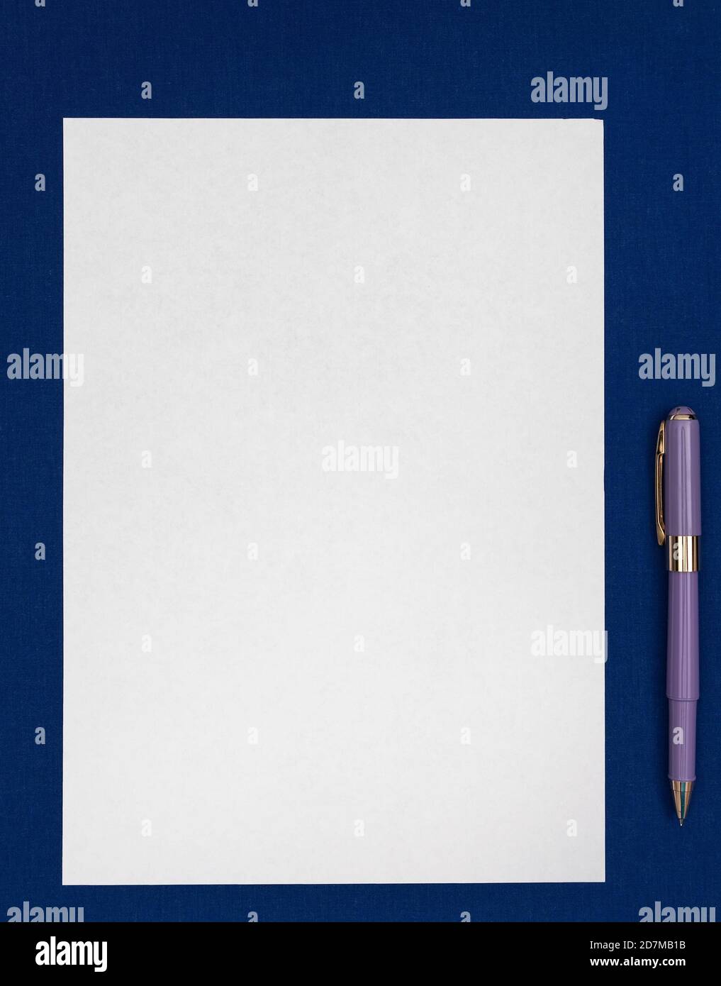 Blank Paper and a Pen on the Blue Fabric Background closeup Stock Photo ...