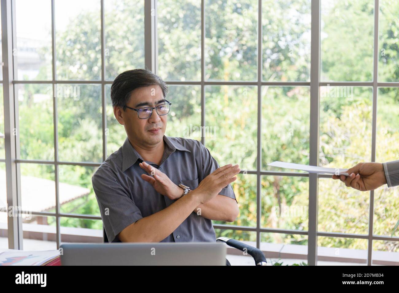 The hand that delivers documents to a grieving Asian middle-aged man ...