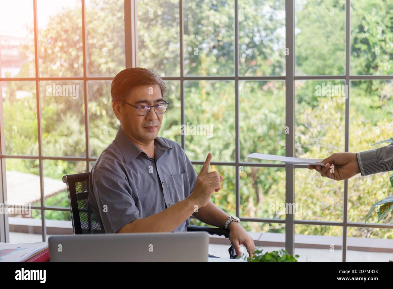 The hand that delivers documents to a grieving Asian middle-aged man ...