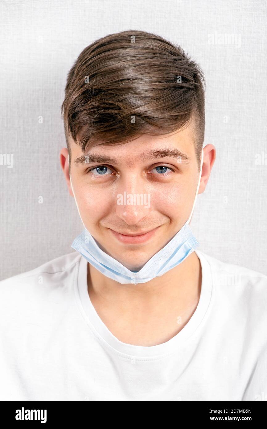 Portrait of Young Man with a Flu Mask by the White Wall closeup Stock ...