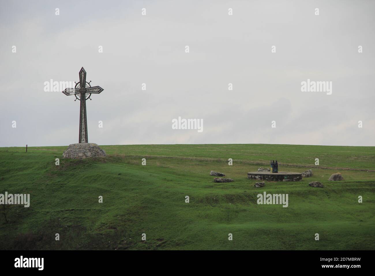 a large cross in a field with green grass Stock Photo - Alamy