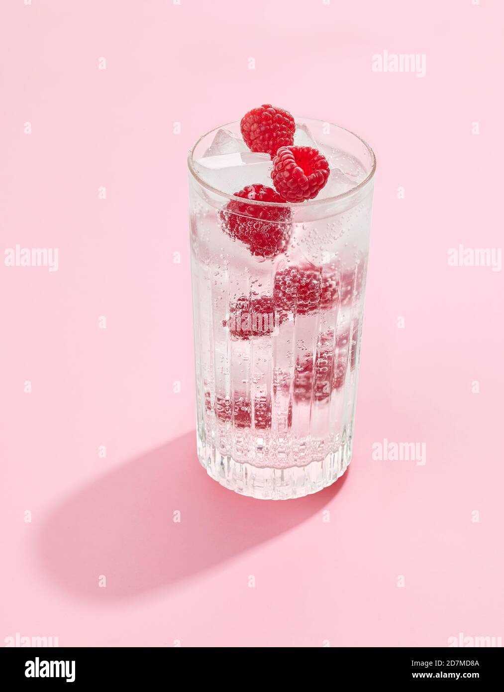 glass of raspberry soft drink on pink background Stock Photo - Alamy