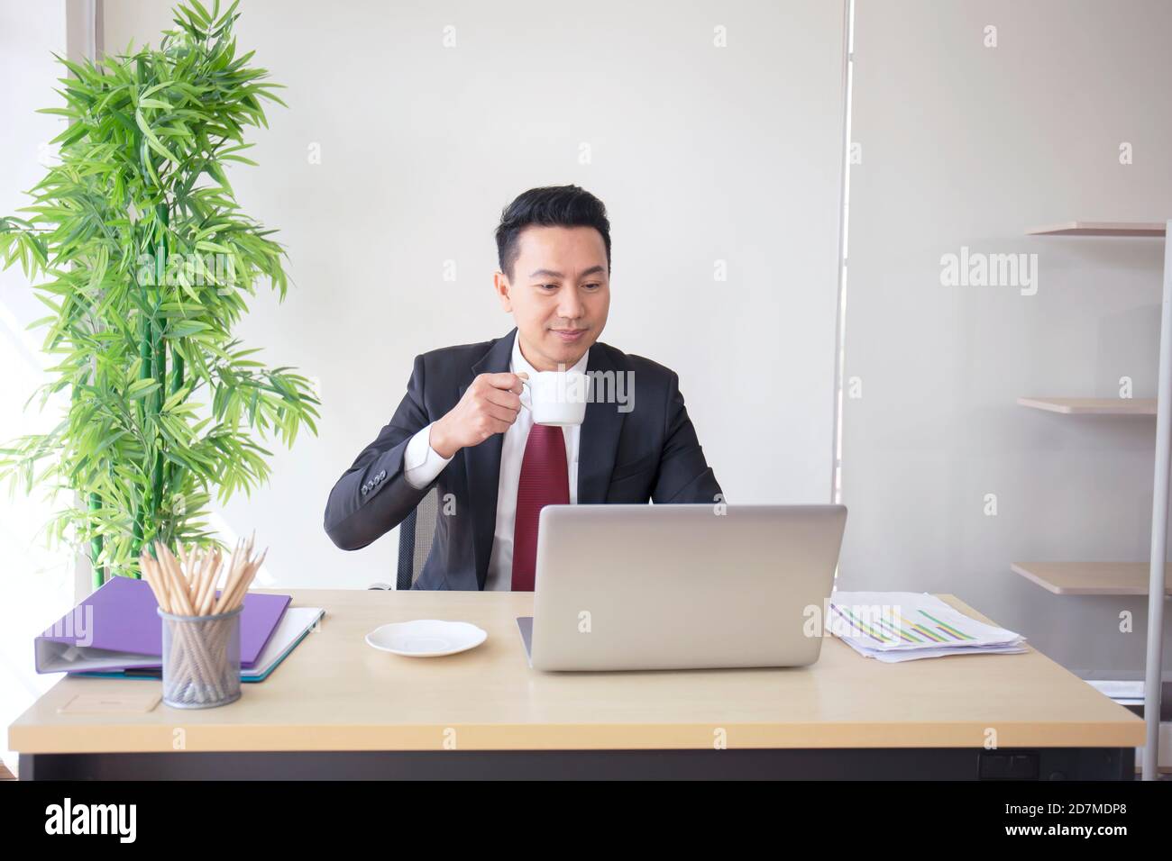 Happy asian man sitting workplace hi-res stock photography and images ...