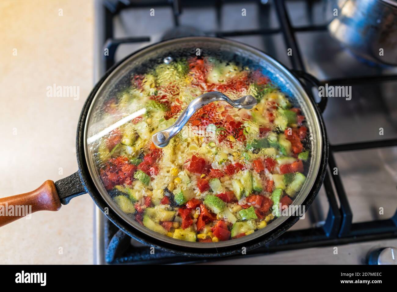 a big pilaf pan bowl with mix of vegetables , cooking on the kitchen ...