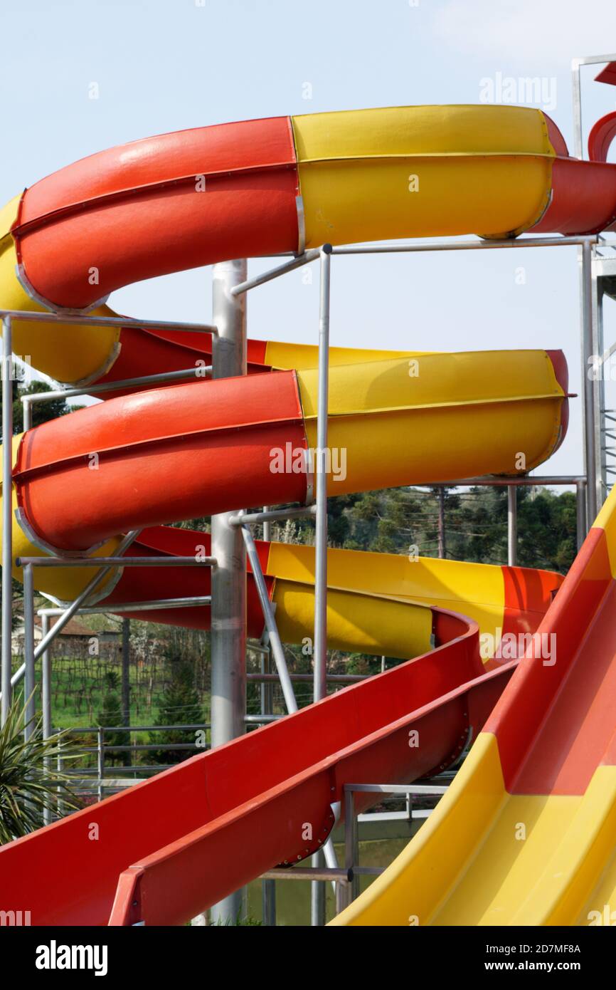 Vertical shot of a turning red and yellow waterslide Stock Photo - Alamy