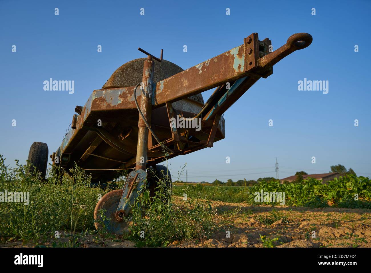 Old manure trailer, rusted drawbar in focus. Vegetable field Stock ...