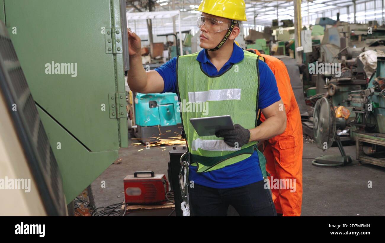 Smart factory worker using machine in factory workshop . Industry and ...