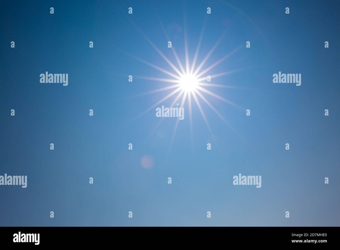 bright sun in a bright blue sky Stock Photo - Alamy