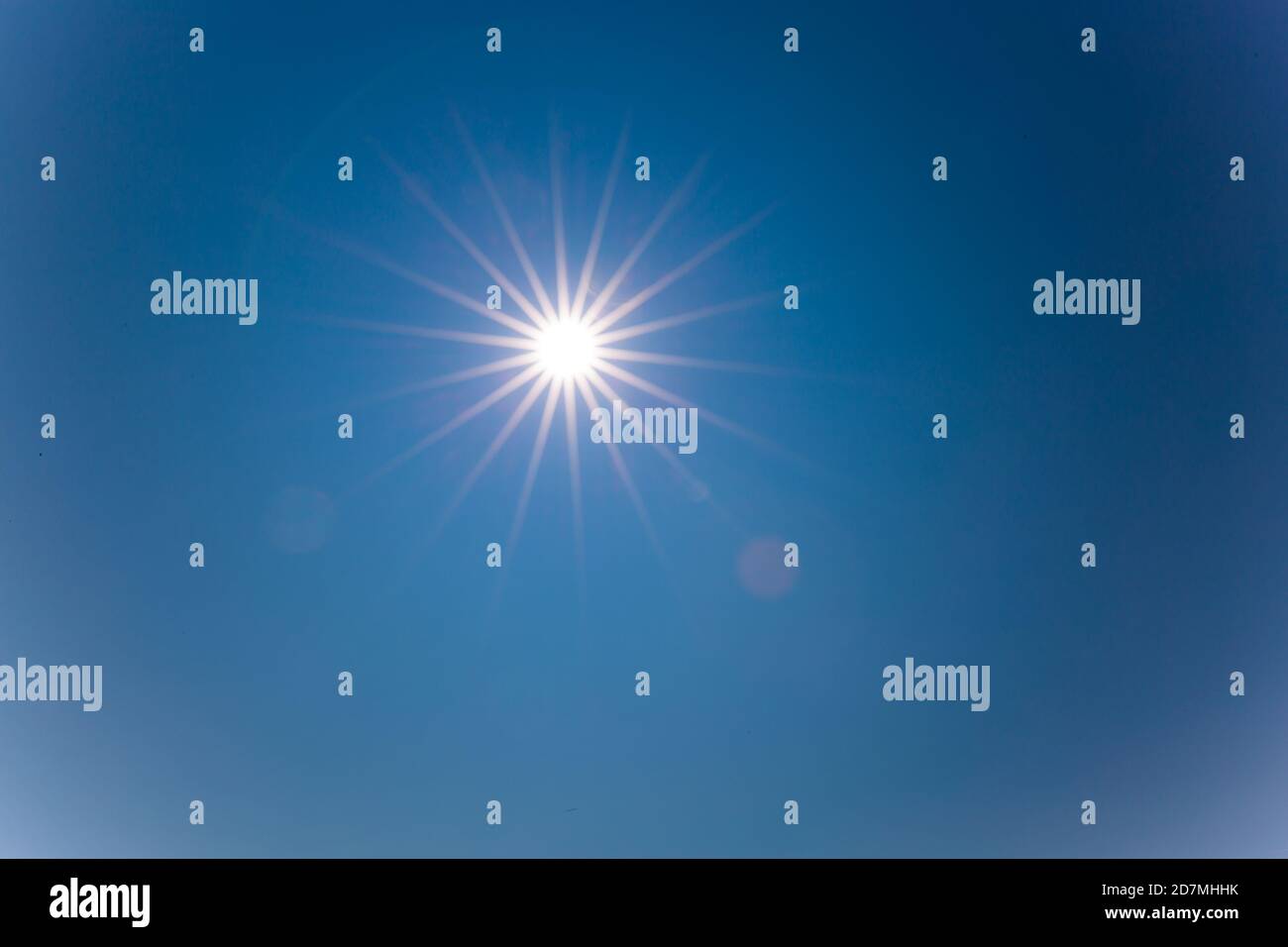 bright sun in a bright blue sky Stock Photo - Alamy
