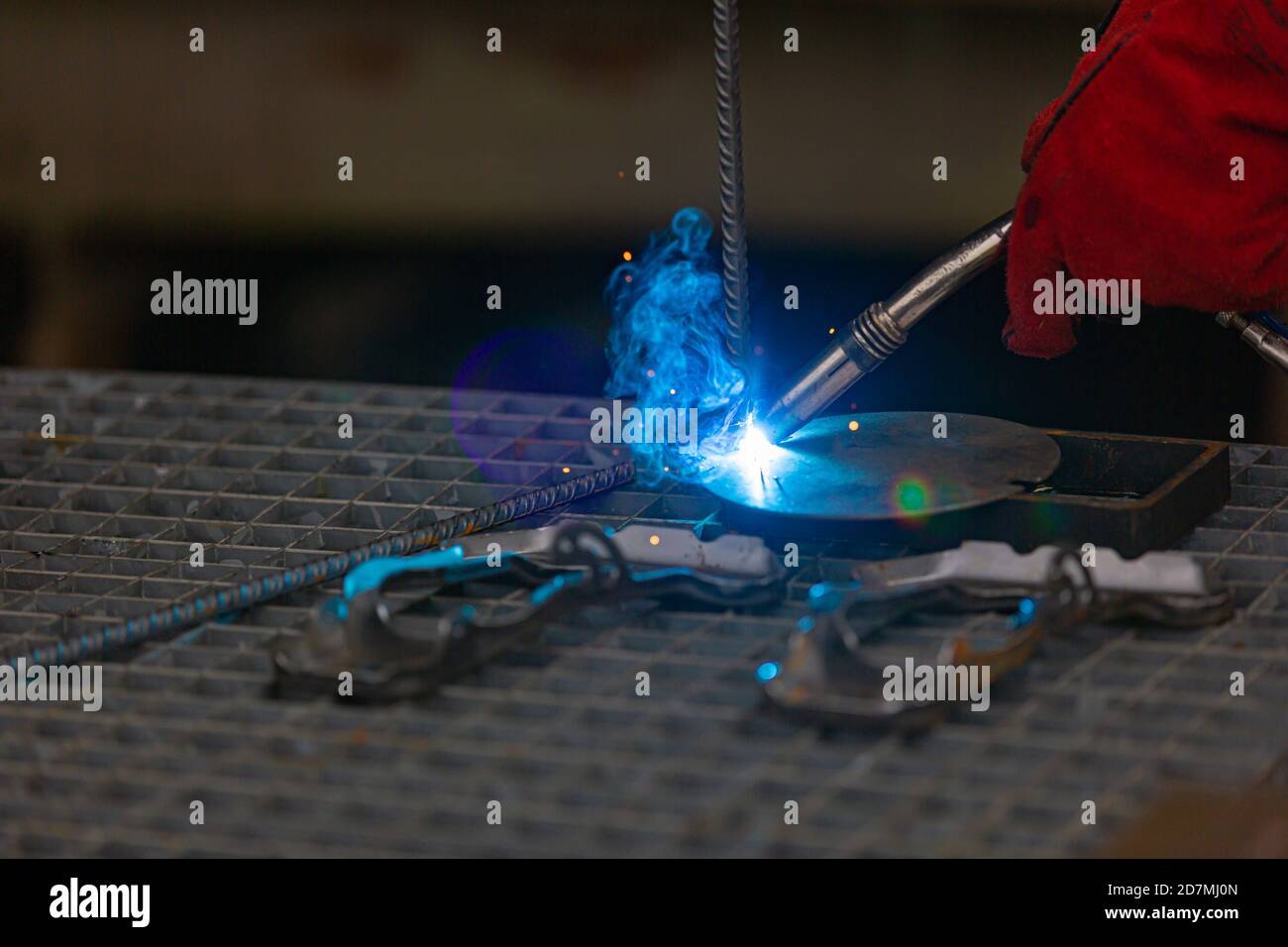 Details of welding activities - a welder is welding steel components ...