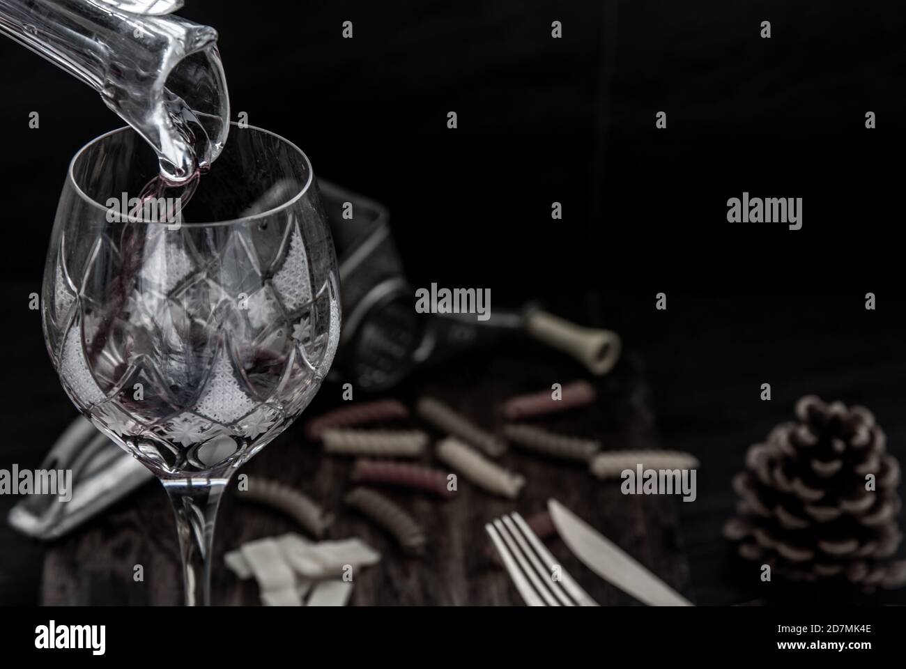Flat lay composition with Pouring red wine from pitcher into the ...