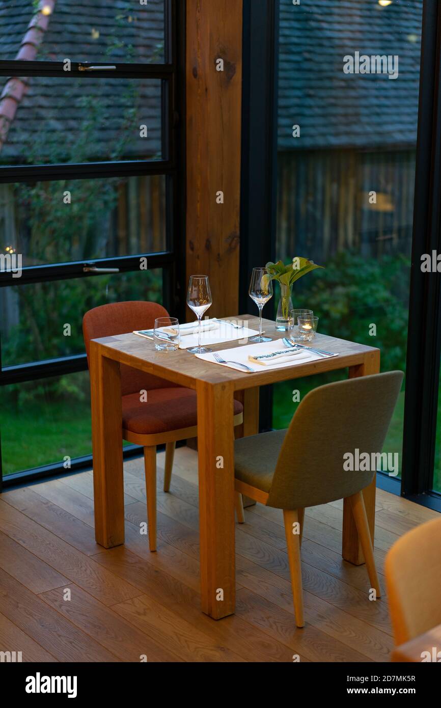 natural evening table setting with wine glasses in unrecognizeble ...