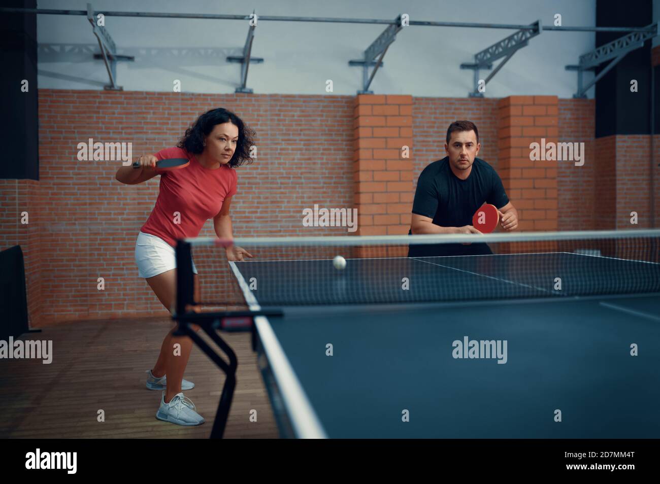 Man and woman play doubles table tennis, ping pong Stock Photo - Alamy