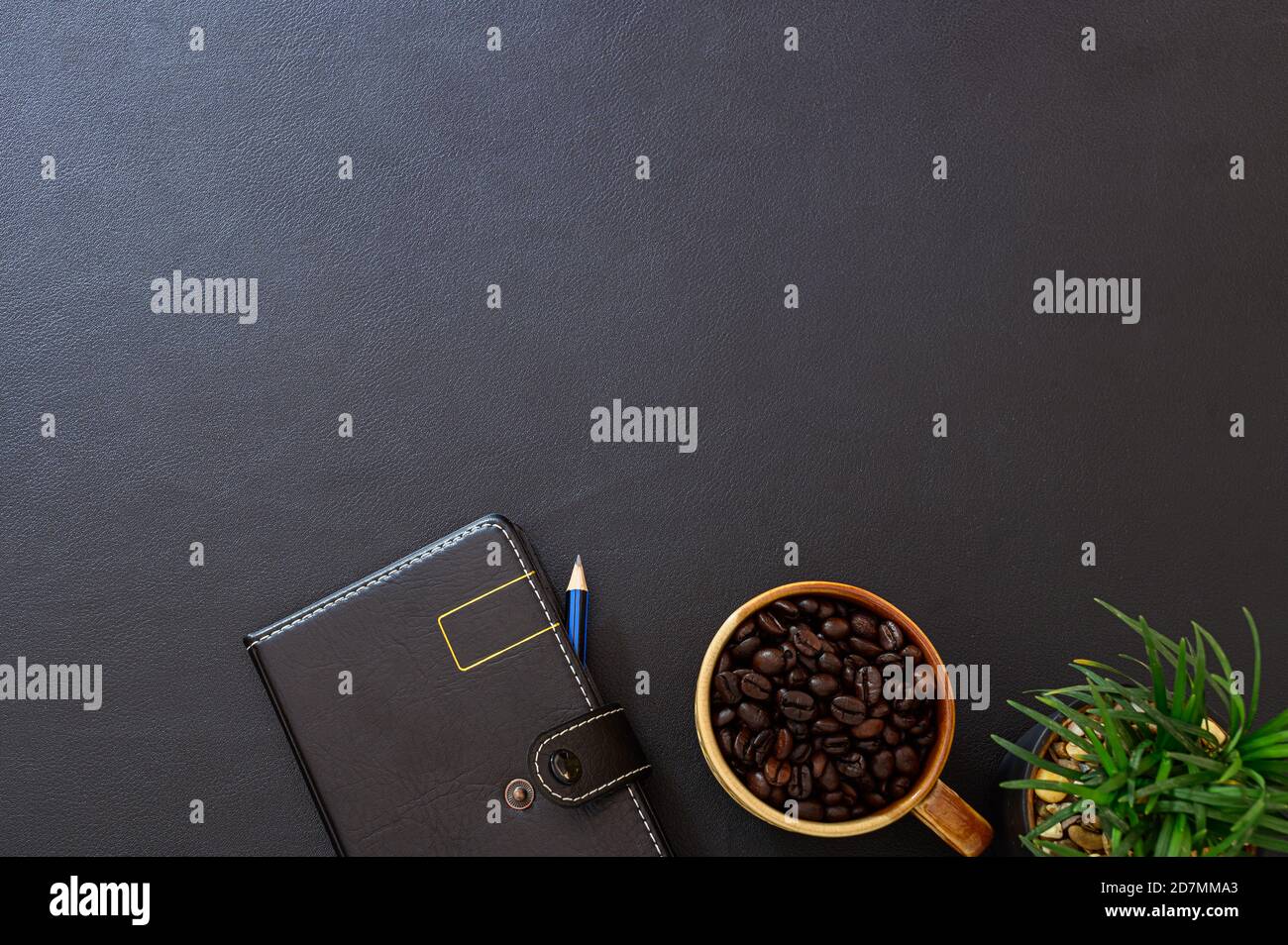 notebook and coffee beans are placed on the desk top view Stock Photo ...