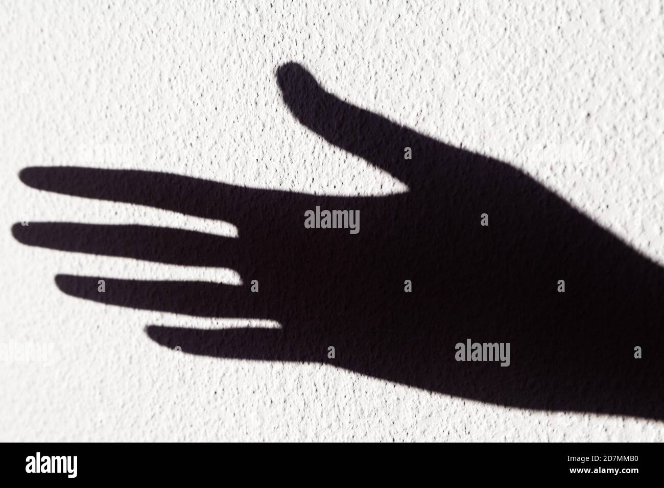 Side view of hand shadow against white textured background Stock Photo ...