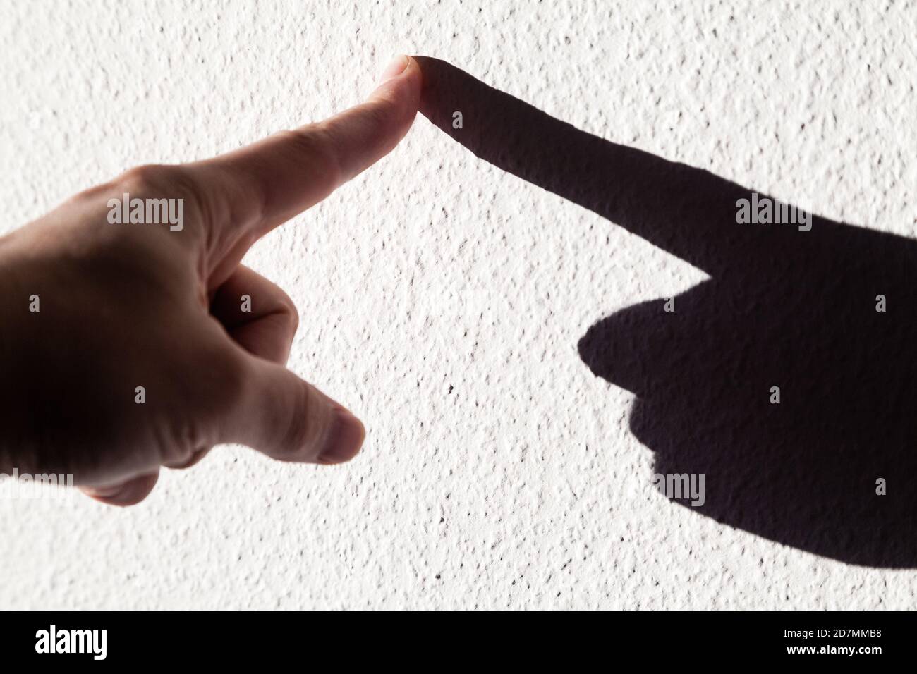 Finger touching wall with dark shadow Stock Photo - Alamy