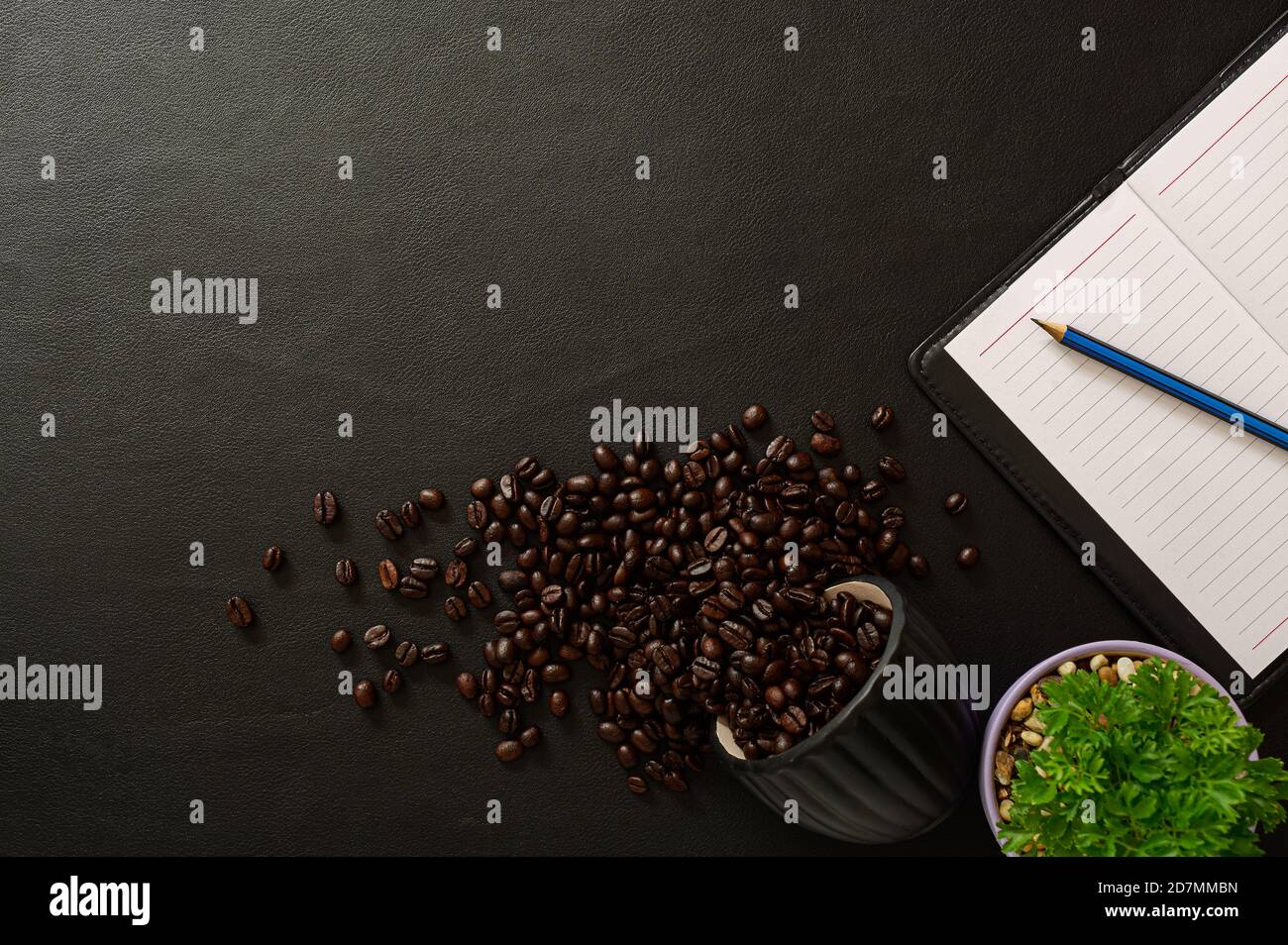 notebook and coffee beans are placed on the desk top view Stock Photo ...