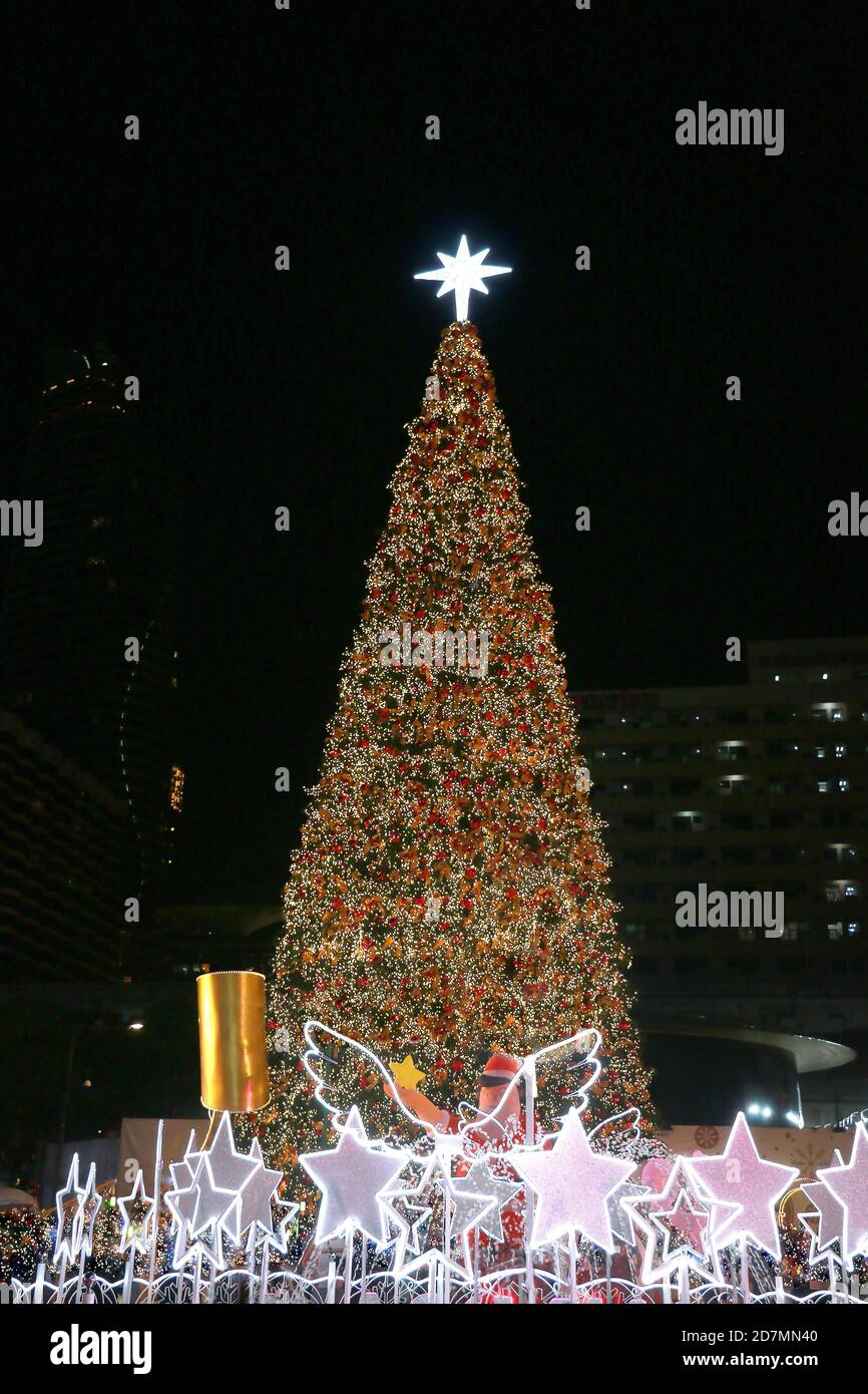 a huge christmas light tree standing in the city night for celebration ...