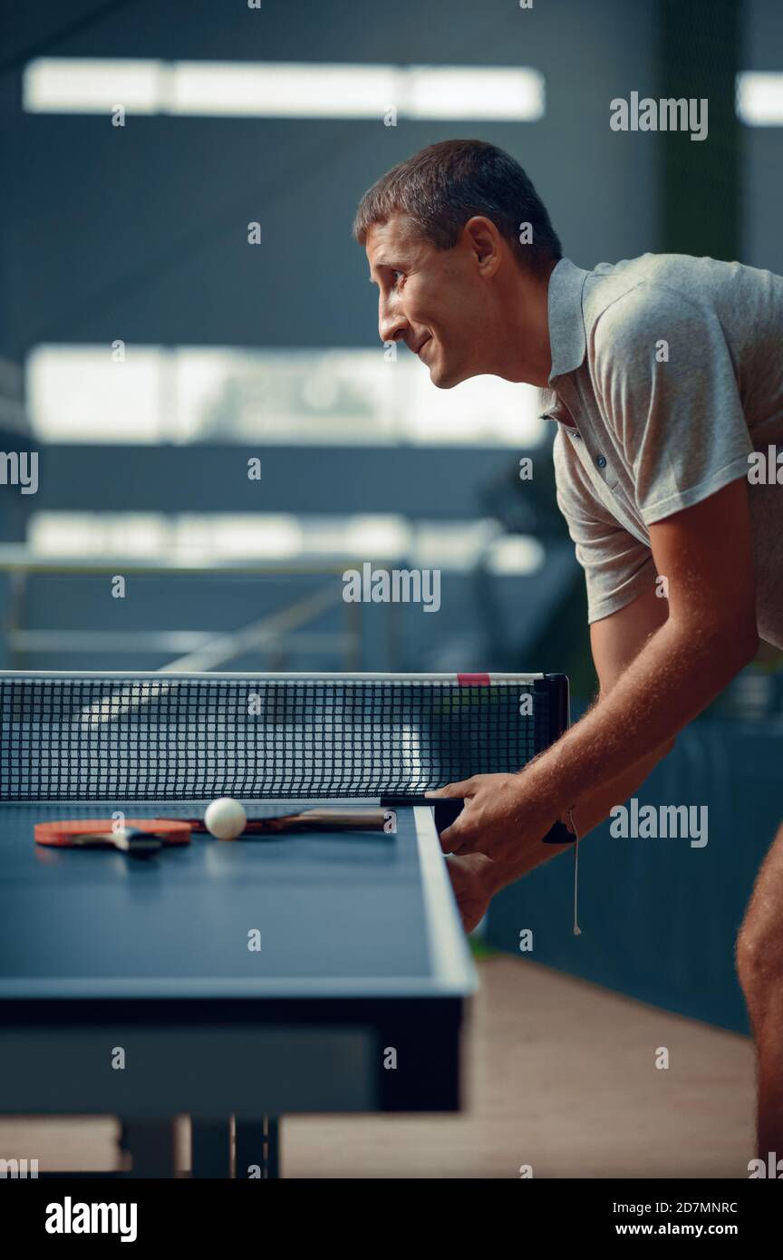 Man at the ping pong table, side view Stock Photo - Alamy