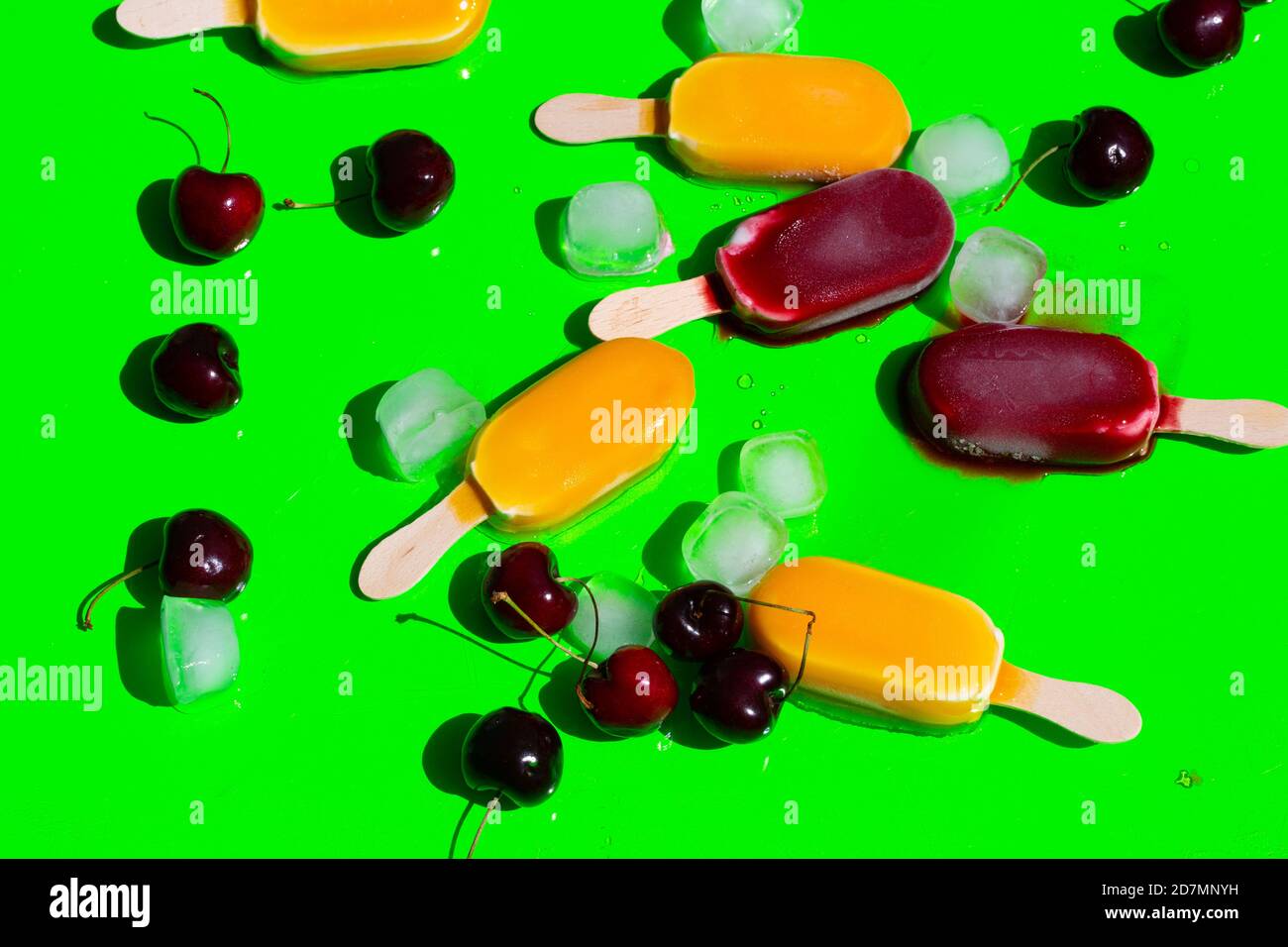 Popsicles, messed with cherries and ice cubes Stock Photo - Alamy