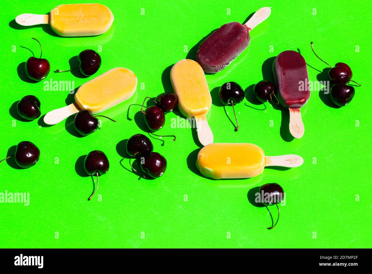 Popsicles, messed with cherries and ice cubes Stock Photo - Alamy